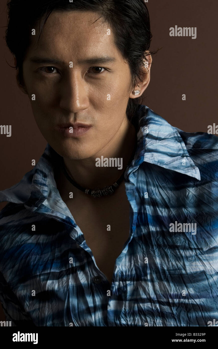 A handsome asian male model in a blue shirt Stock Photo - Alamy