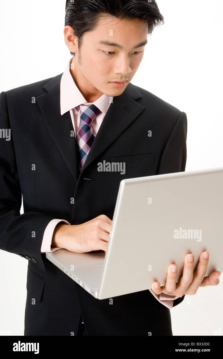 A young asian businessman working on a laptop computer Stock Photo - Alamy