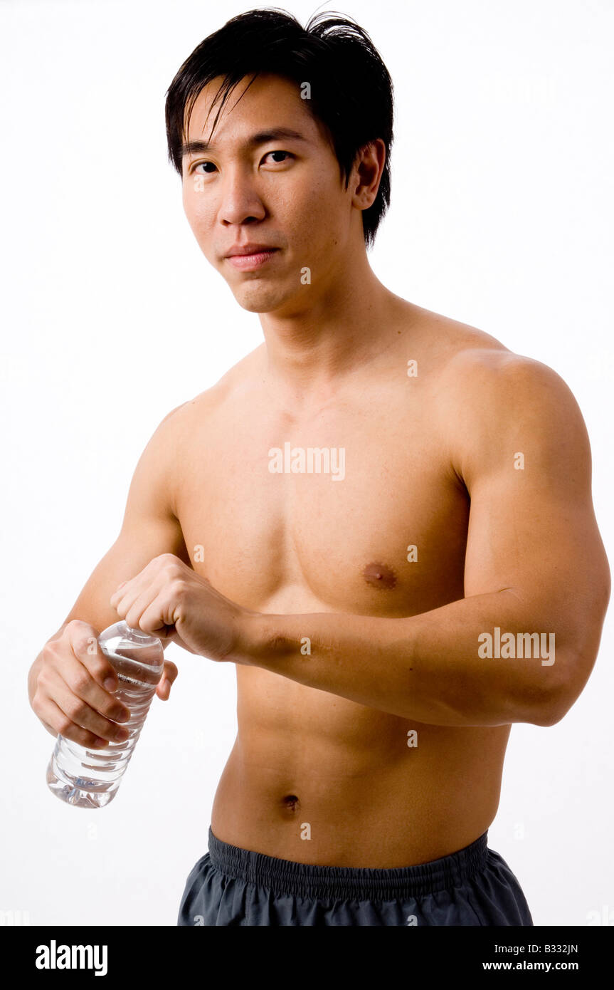 A well-built asian man holding a water bottle Stock Photo - Alamy