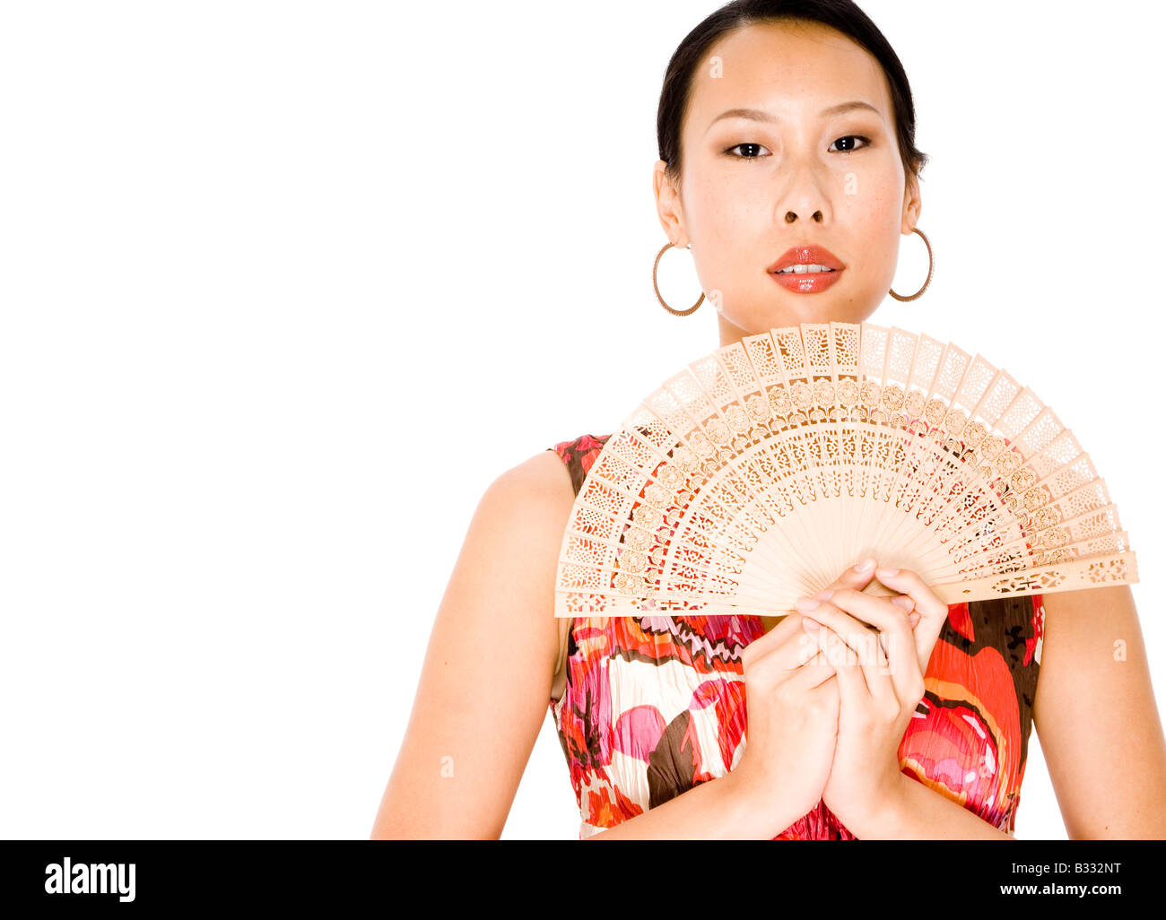 A beautiful asian model holding a wooden fan Stock Photo - Alamy