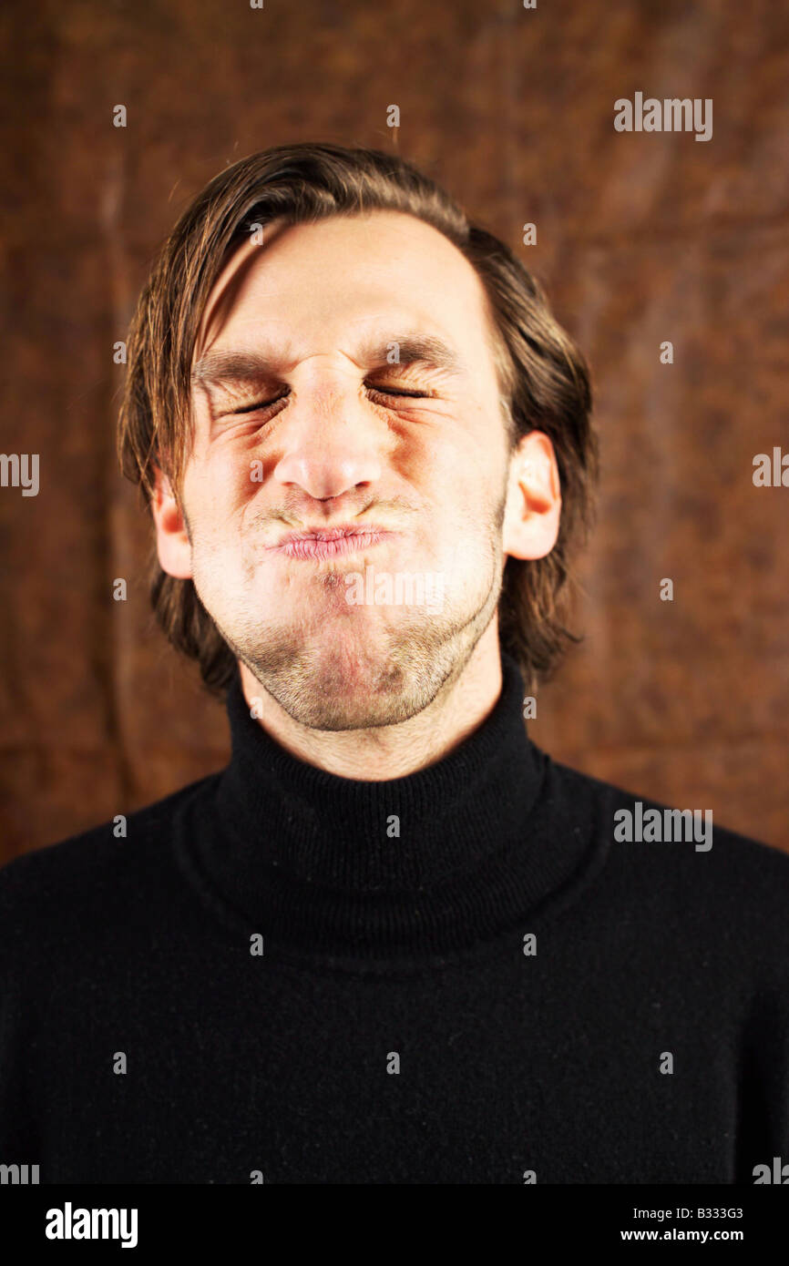 a young man making a face, portrait Stock Photo - Alamy