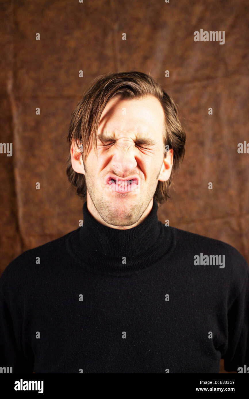 a young man making a face, portrait Stock Photo - Alamy