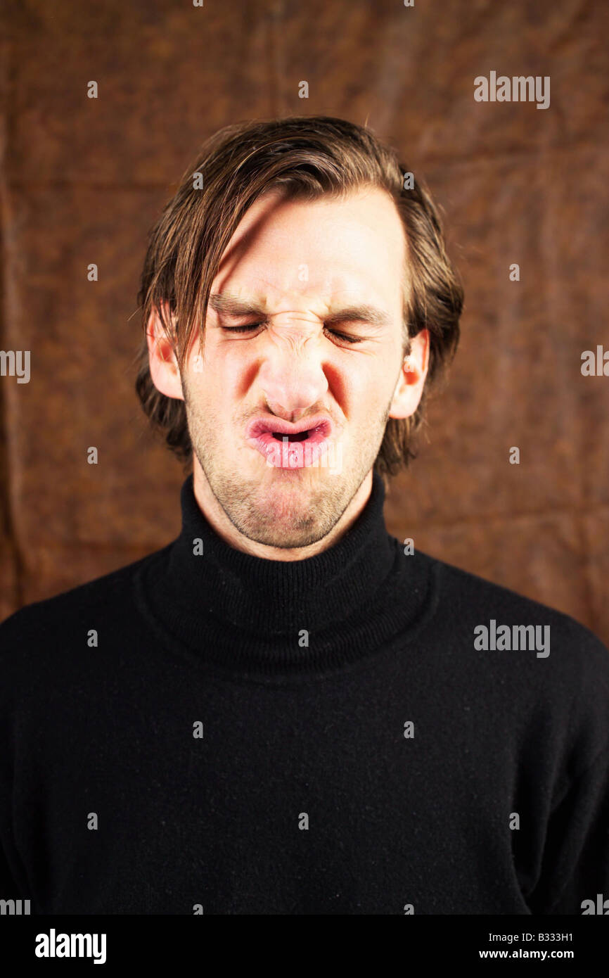 a young man making a face, portrait Stock Photo - Alamy