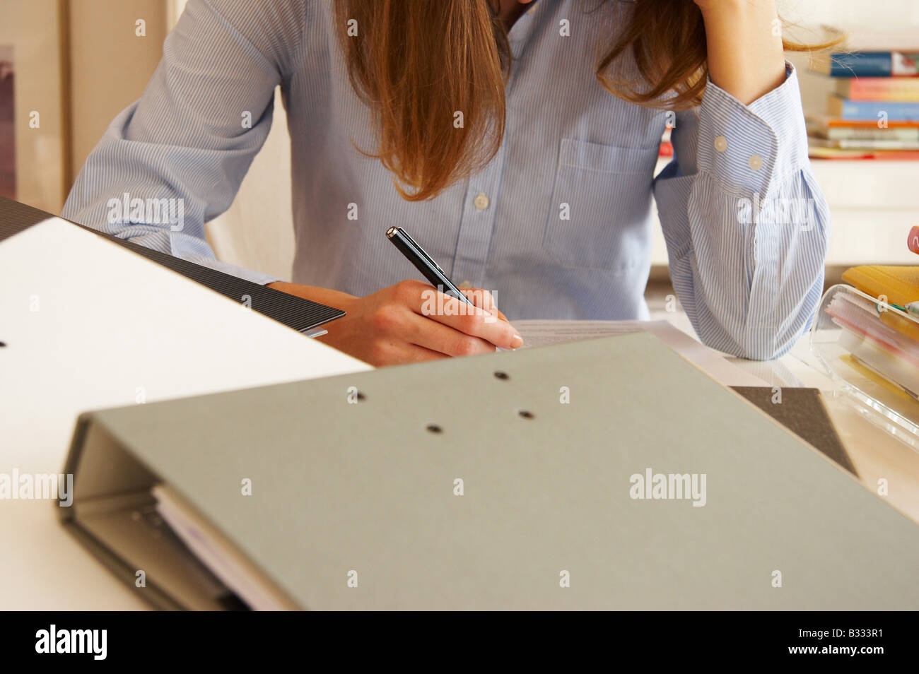 young working at her writing desk Stock Photo - Alamy