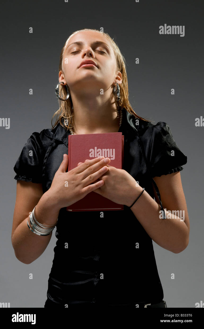 Blond woman with a red book Stock Photo - Alamy