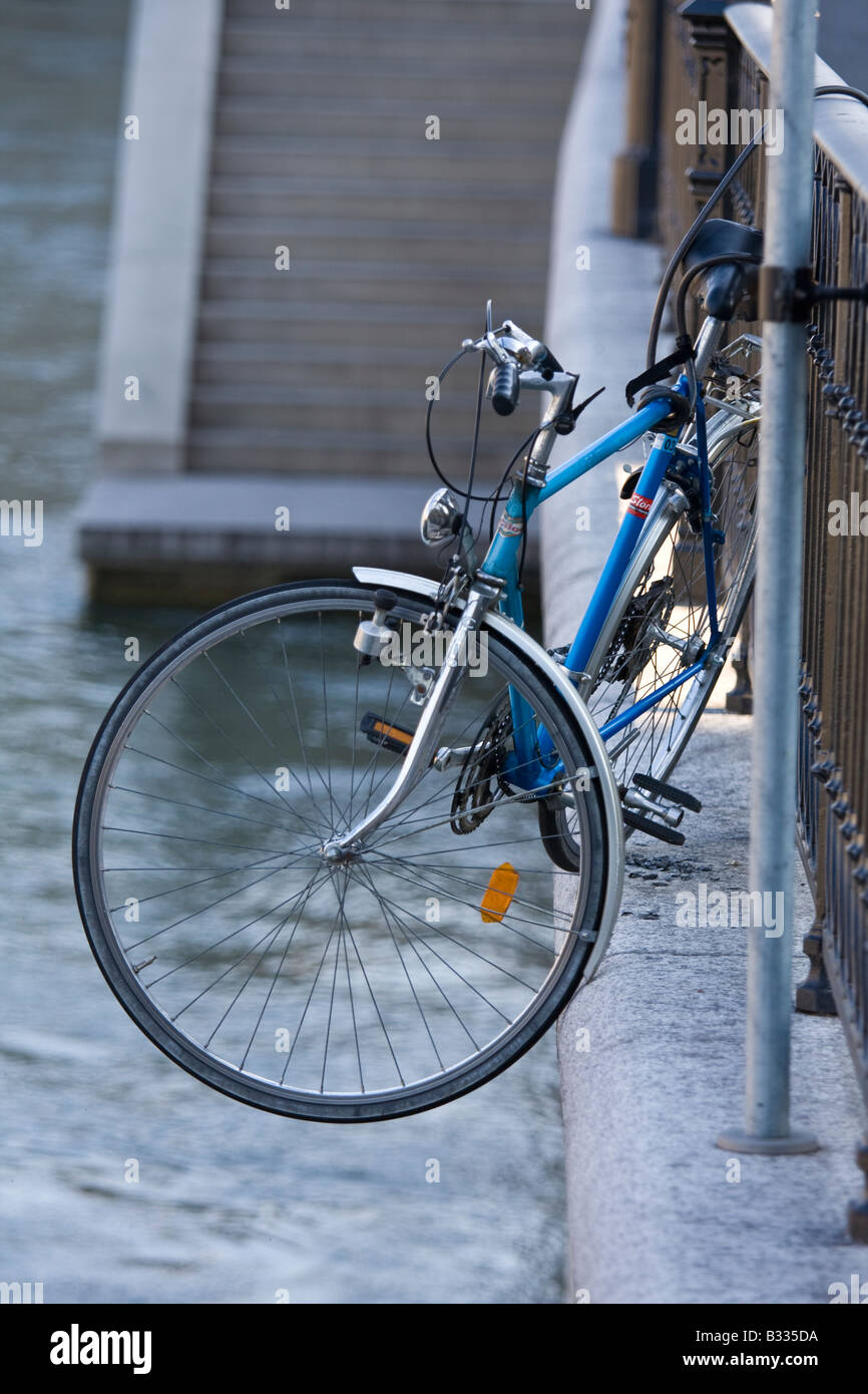 bicycle hanging on handrail of bridge Stock Photo - Alamy