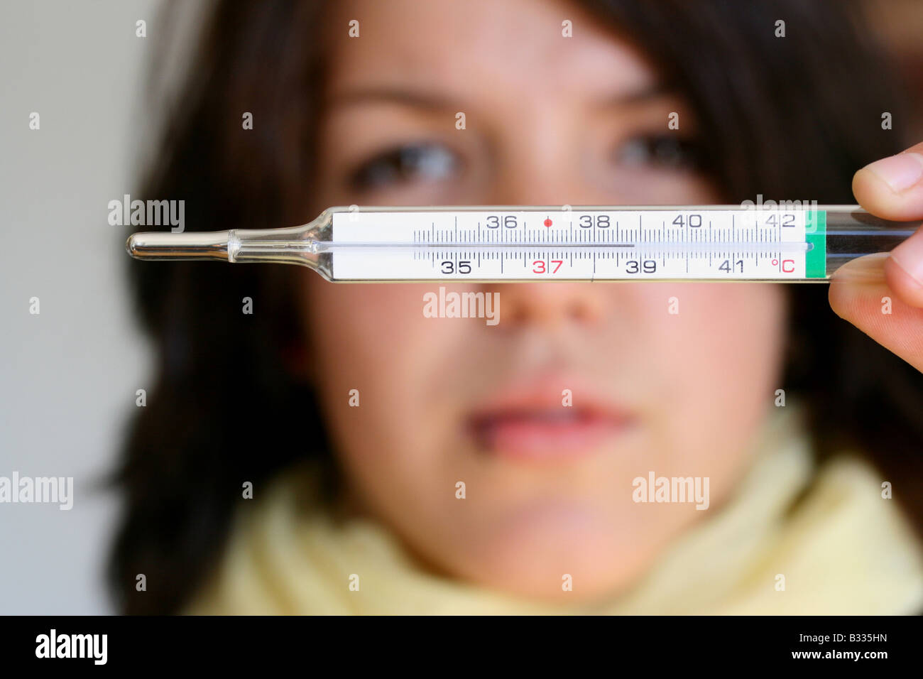Young woman with clinical thermometer Stock Photo - Alamy