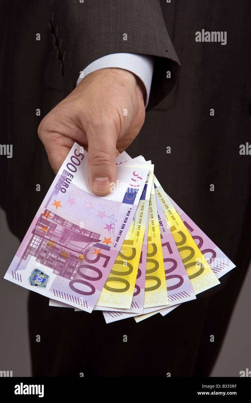 Hand with euro bank notes Stock Photo - Alamy
