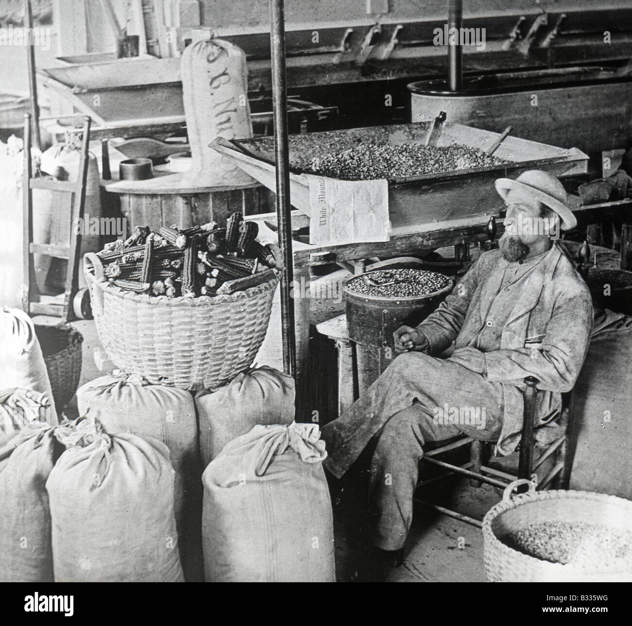 Circa 1890s photograph of a farmer in an old grist mill Stock Photo - Alamy