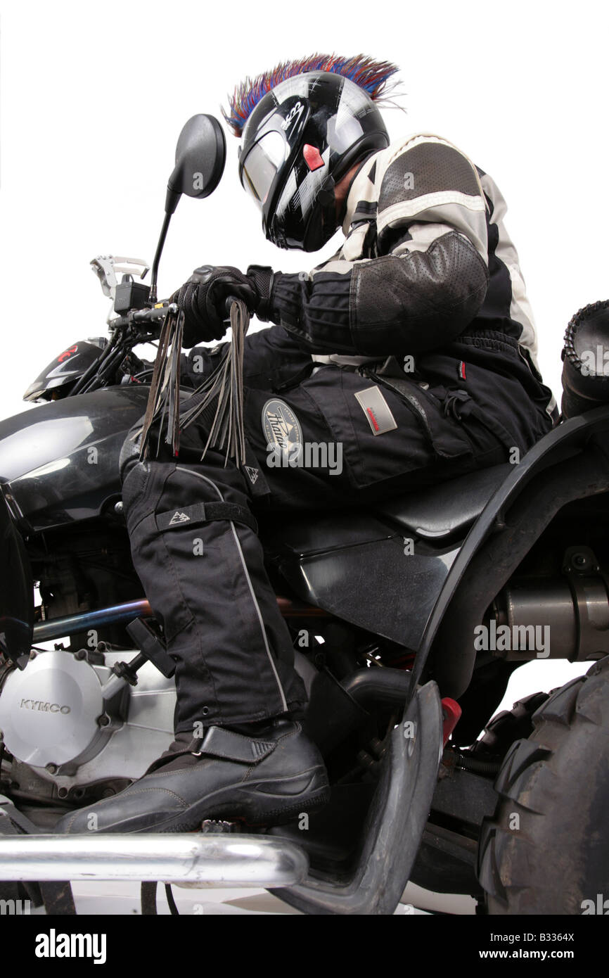 quod biker with helmet and vehicle Stock Photo - Alamy