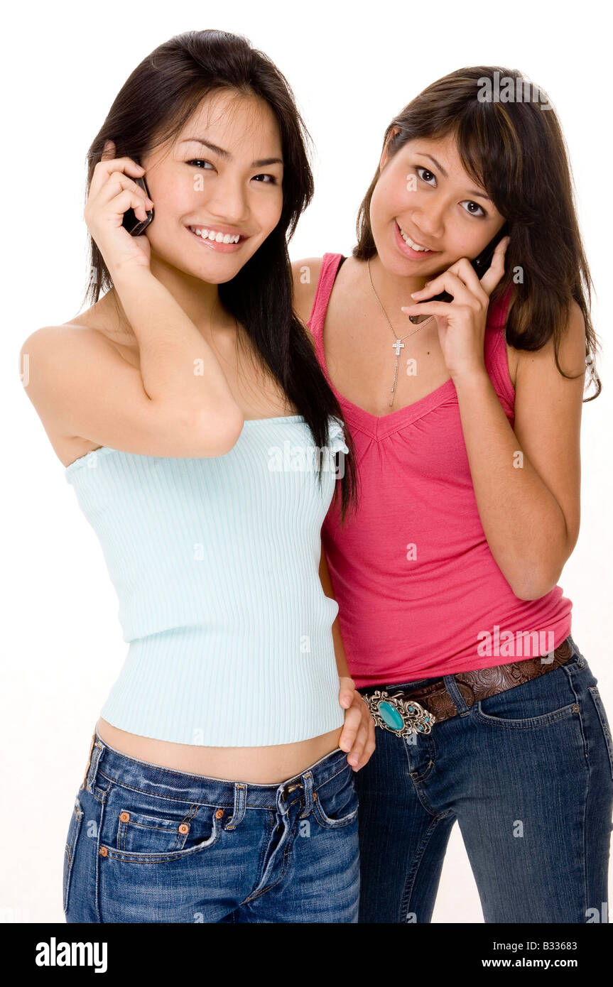 Two pretty young women on the phone Stock Photo - Alamy