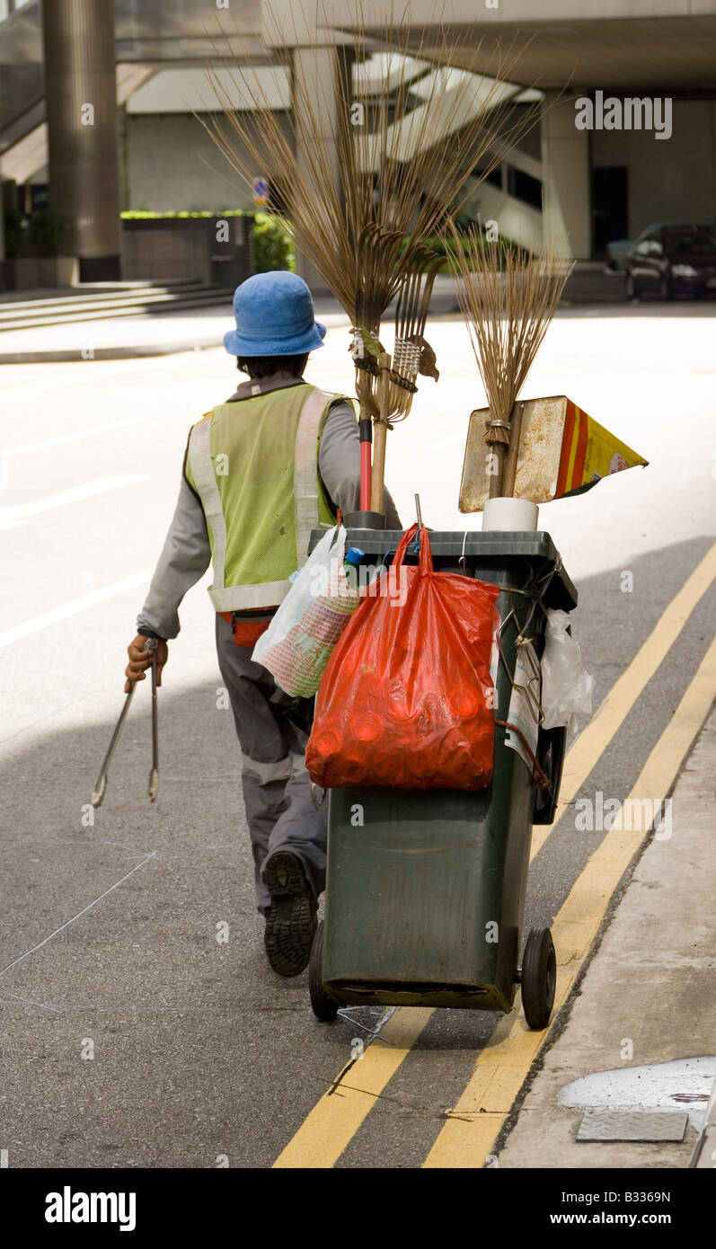 A street cleaner pulls his cart in the streets of Singapore Stock Photo ...