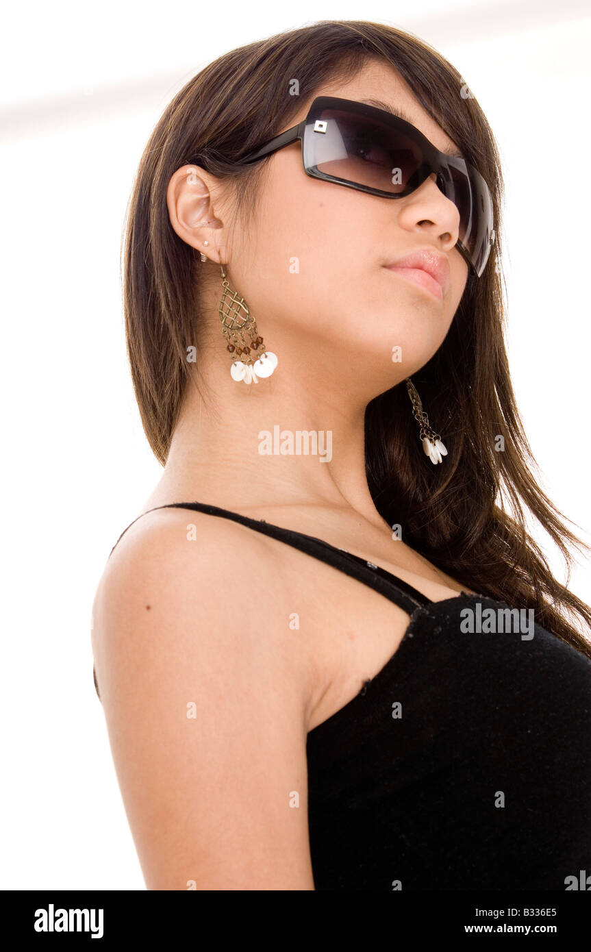 A cool young woman in black on white Stock Photo - Alamy