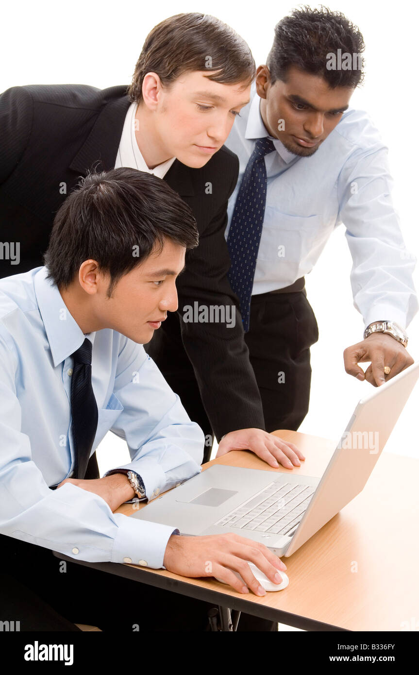 Three businessmen work on a laptop computer Stock Photo - Alamy