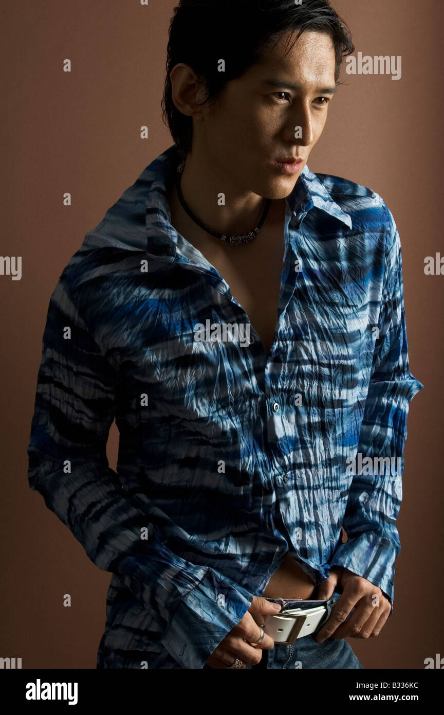 An asian male model in a patterned blue shirt Stock Photo - Alamy