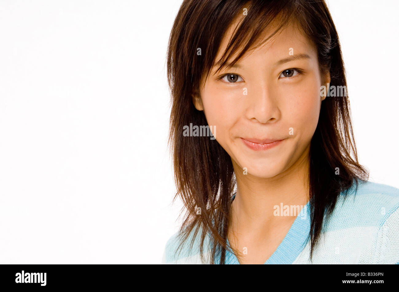 A funny young asian woman pulling an odd smile Stock Photo - Alamy