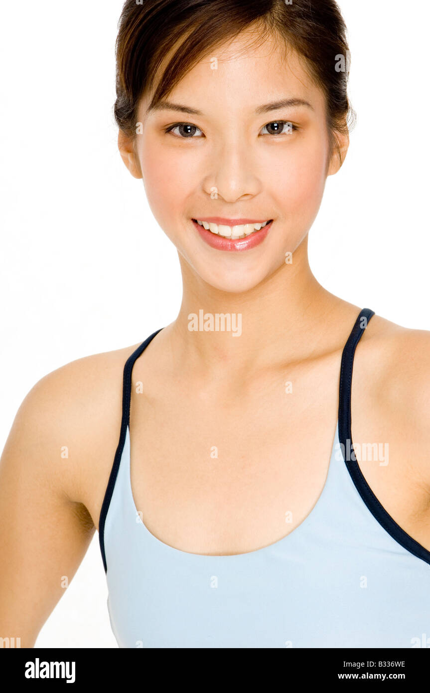A pretty young asian fitness trainer in blue sports top on white ...