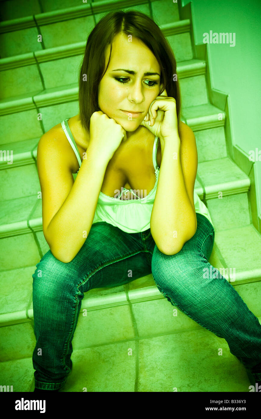 girl sitting on stairs and is sad Stock Photo - Alamy