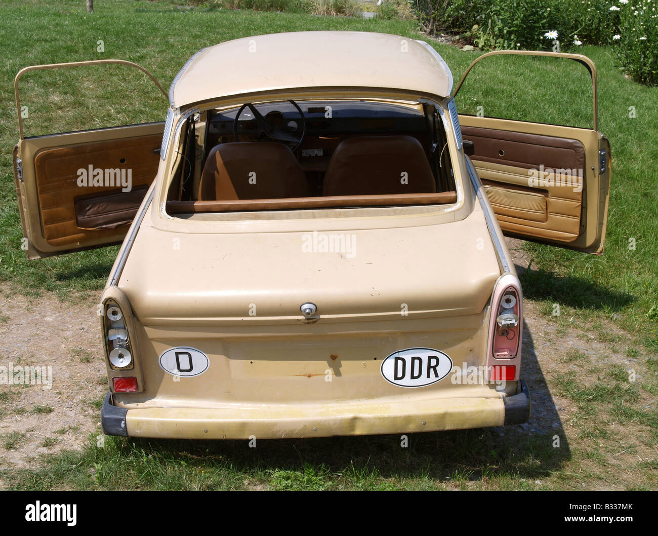 Trabant standing on a lawn with open doors and license plates of ...