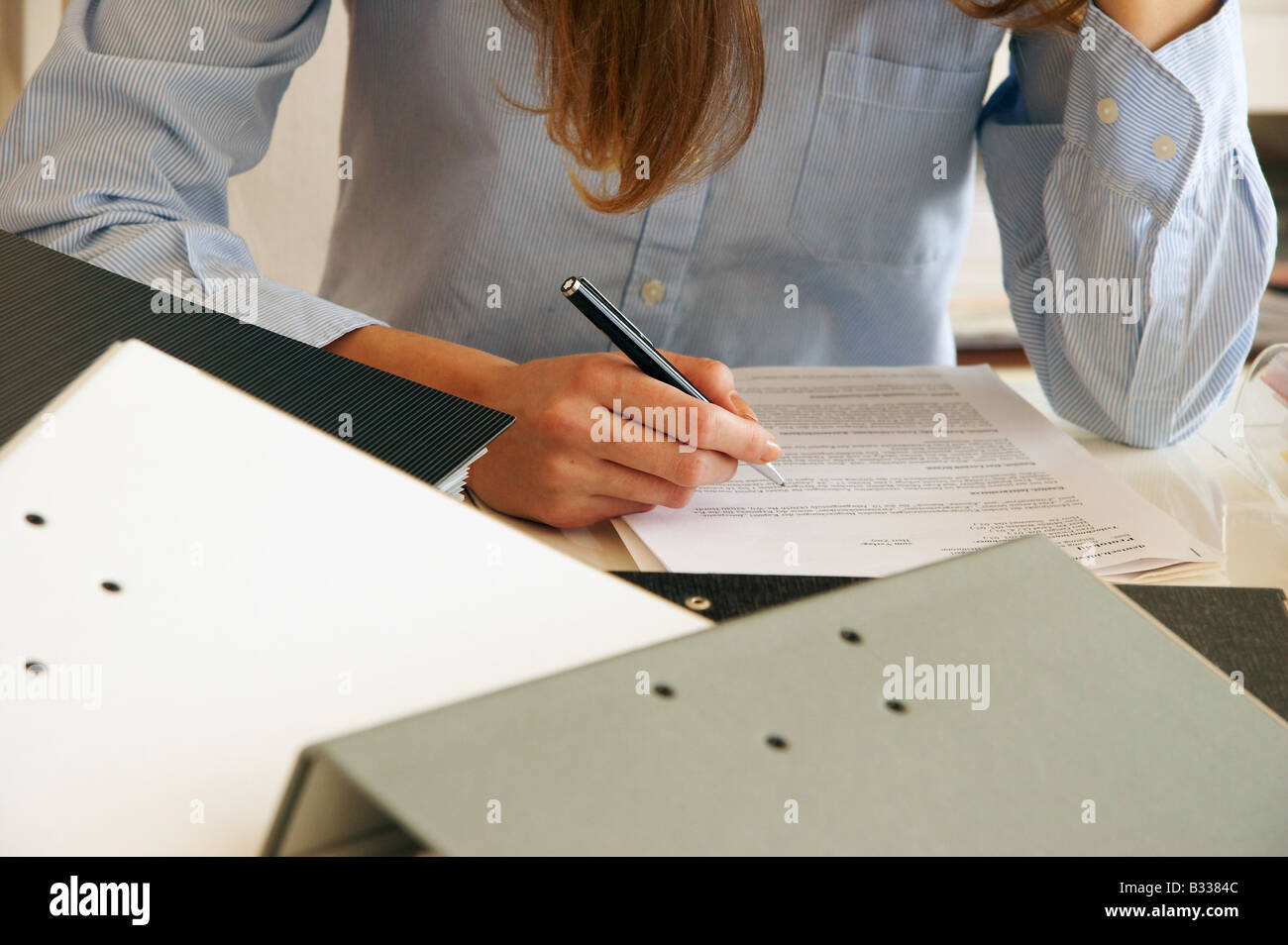 young working at her writing desk Stock Photo - Alamy