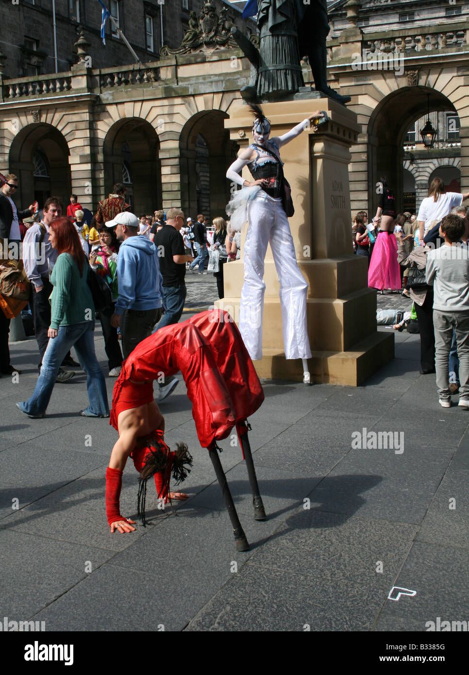 woman wearing stilts performing acrobatics promoting her show at ...
