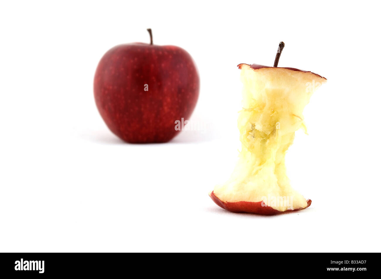 An apple core with an apple in the background Stock Photo - Alamy