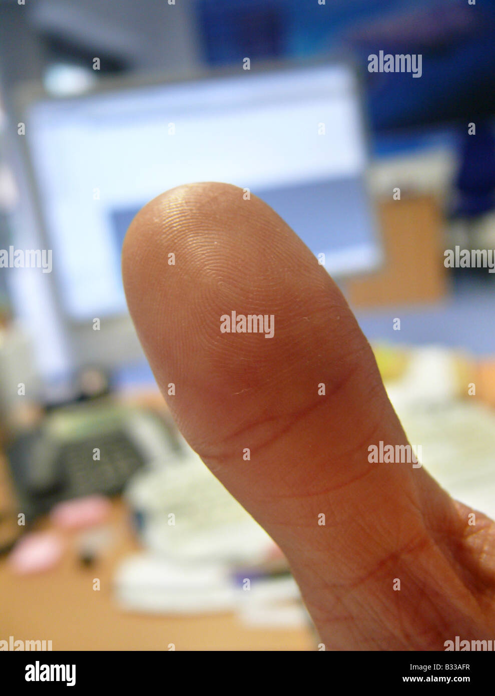 thumb in front of a computer monitor Stock Photo - Alamy