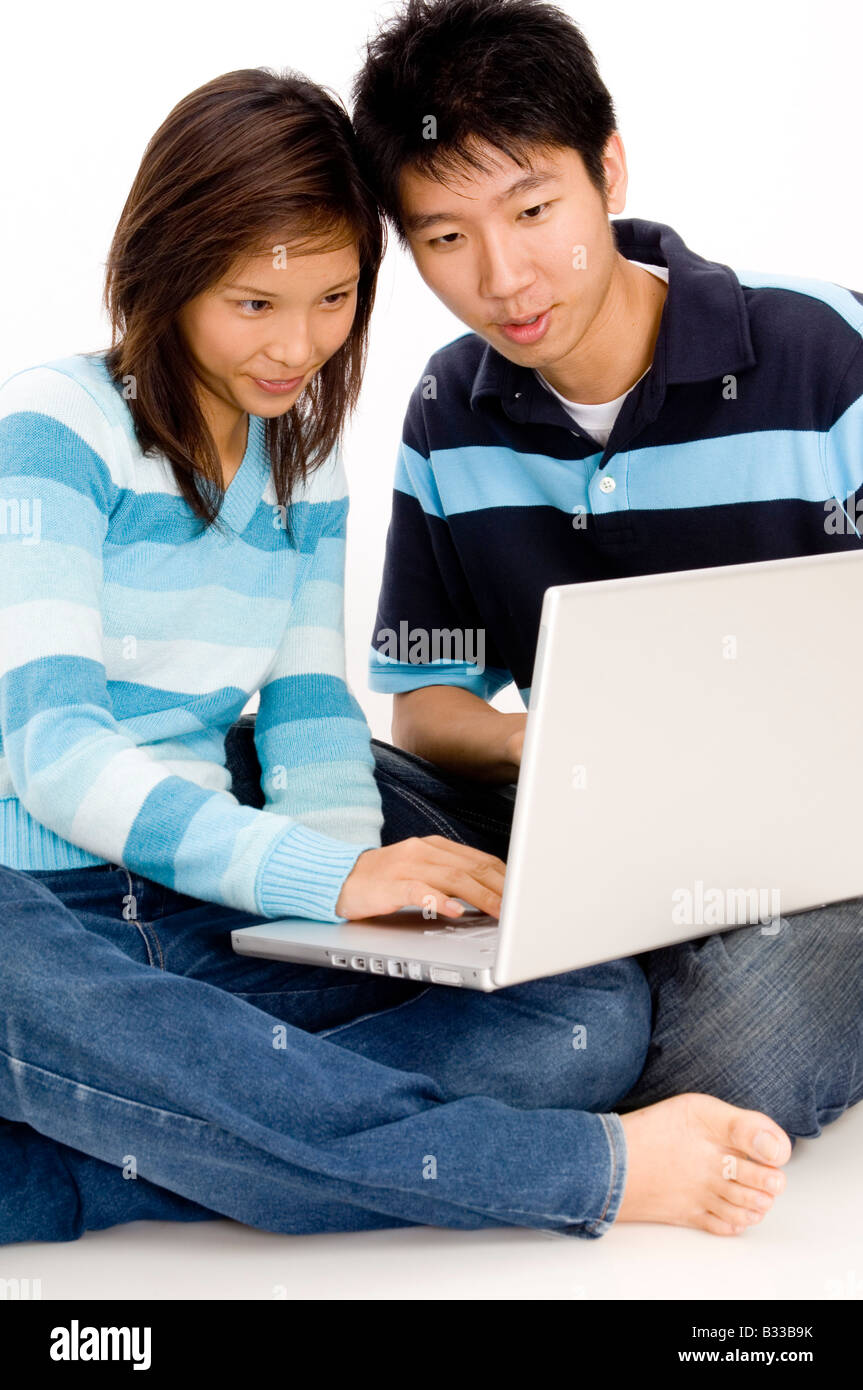 A young asian couple using a laptop computer Stock Photo - Alamy