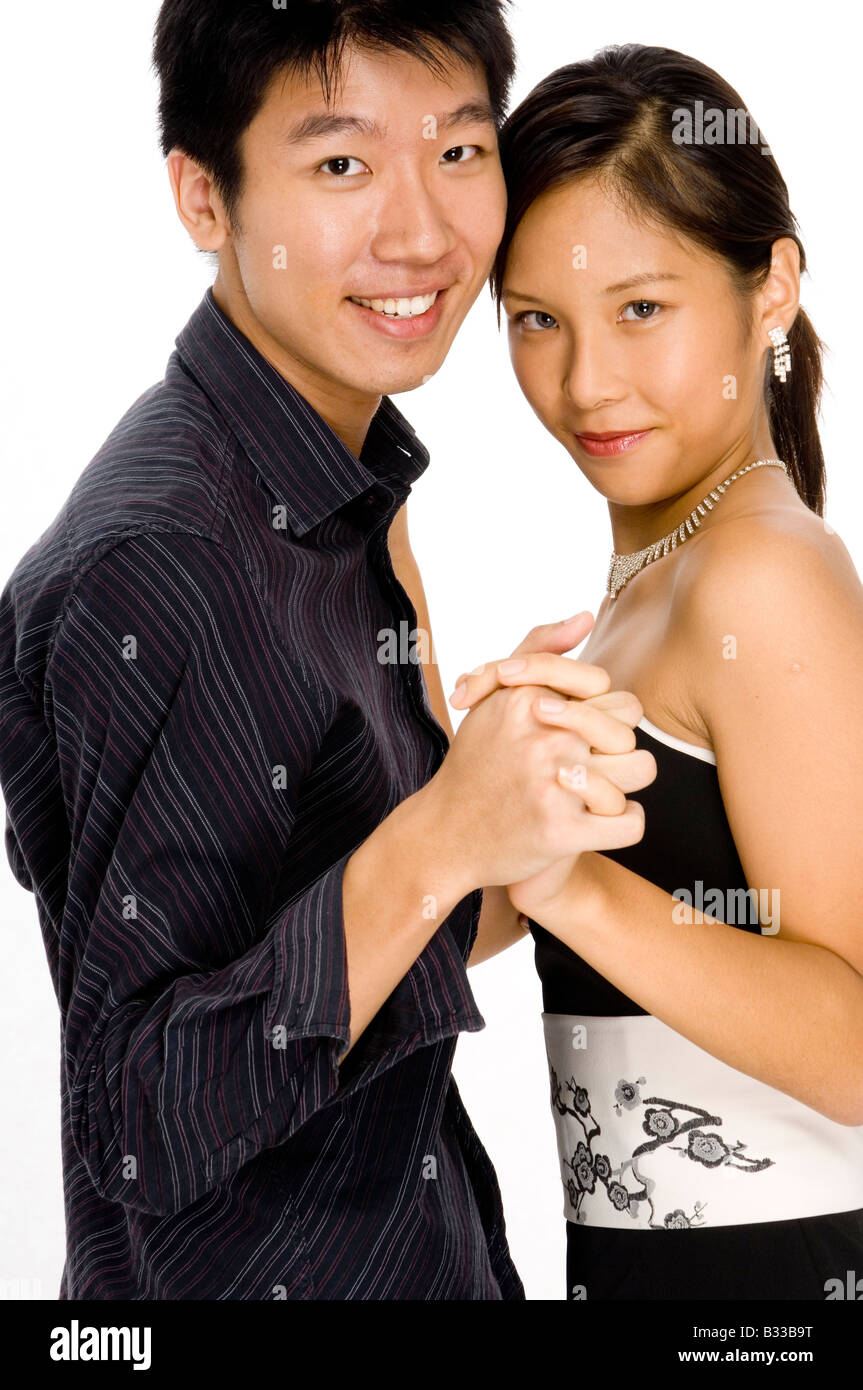 A young asian couple stand closely and hold hands Stock Photo - Alamy