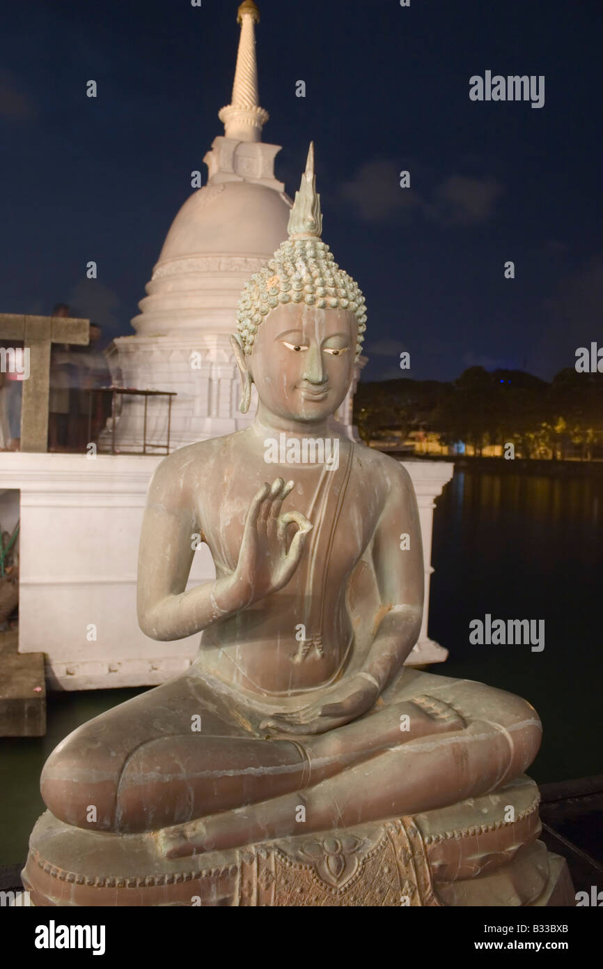 Statue of Buddha sits outside lake temple in Colombo, Sri Lanka Stock ...