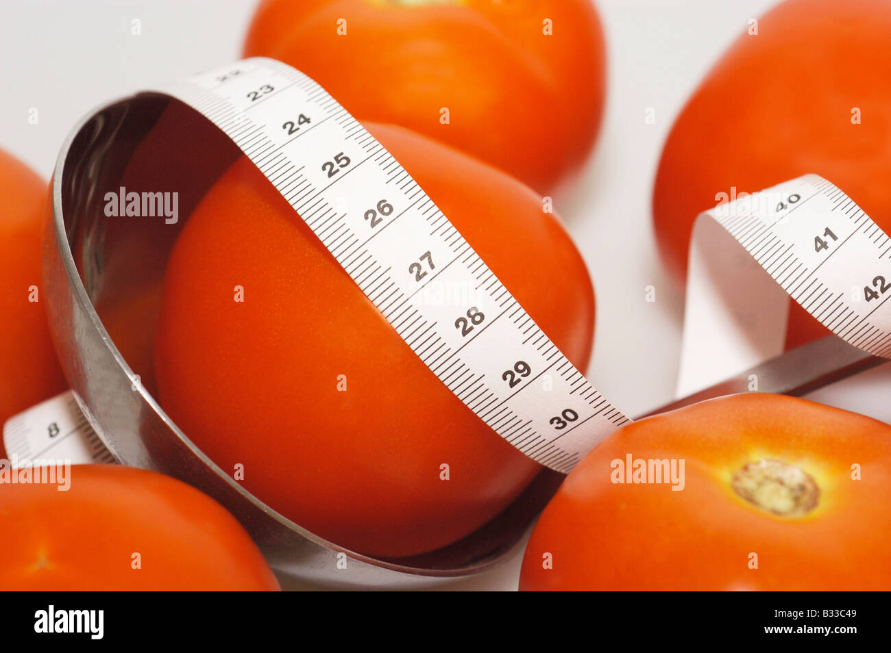 Tomatoes with measuring tape Stock Photo - Alamy
