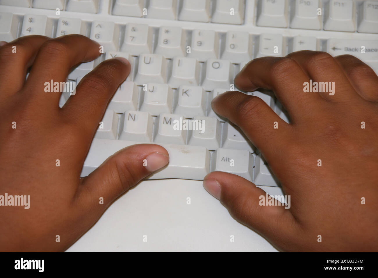 Boys hands on typing on keyboard Stock Photo - Alamy
