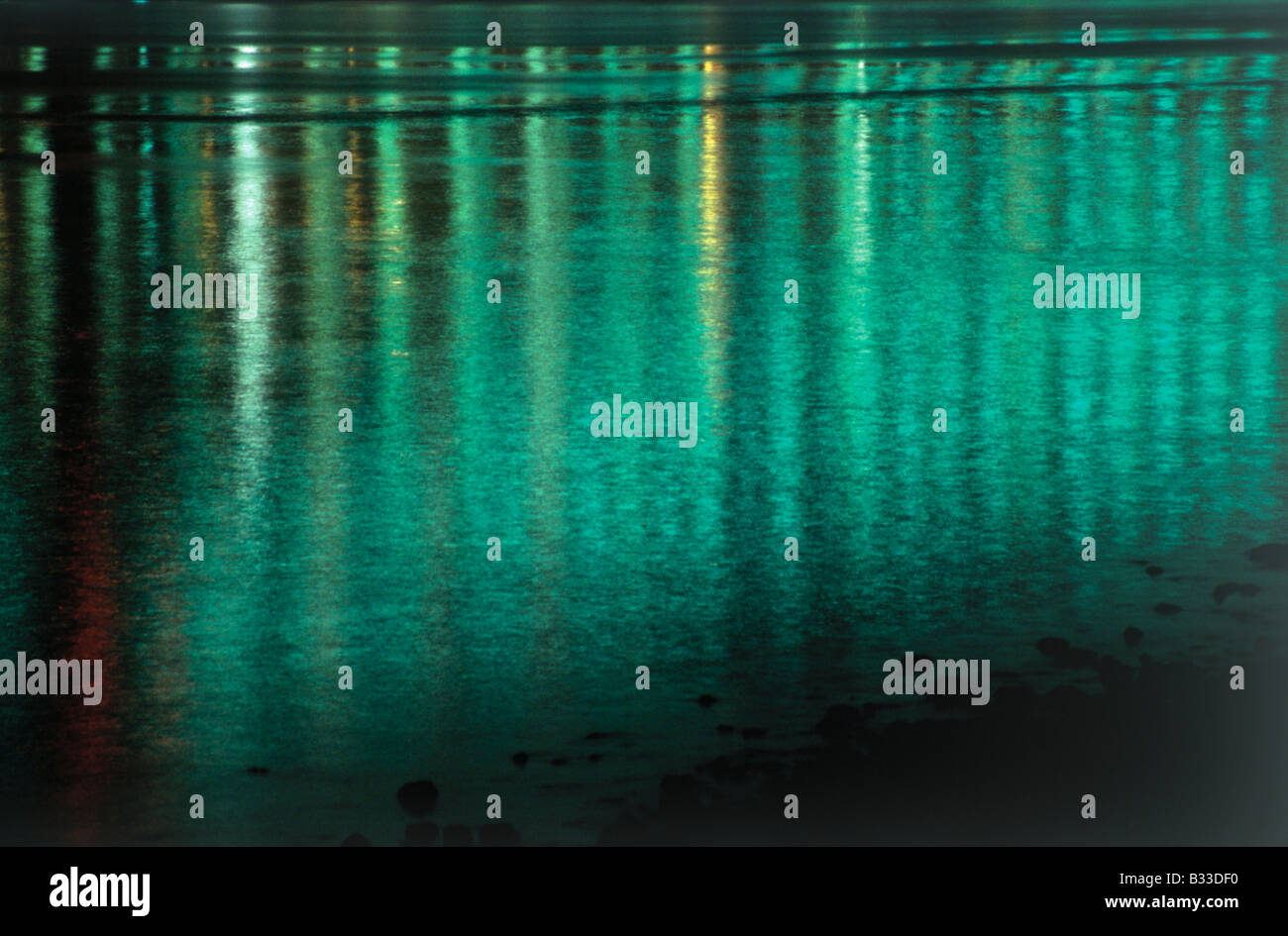 Reflection of green lights on water at night Stock Photo - Alamy