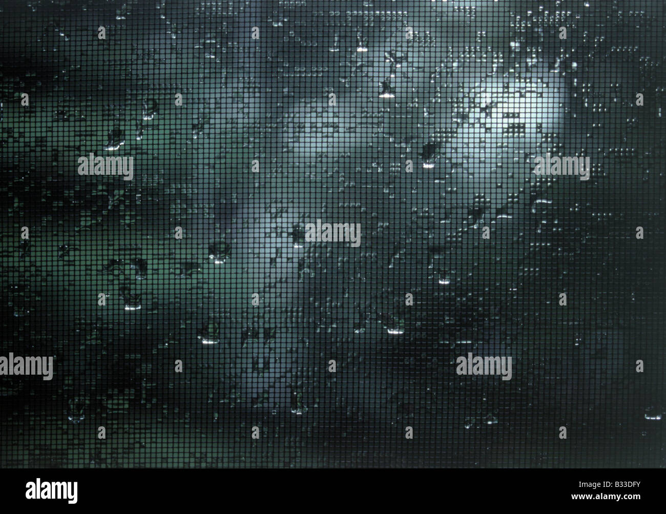 Water on window screen at night Stock Photo - Alamy