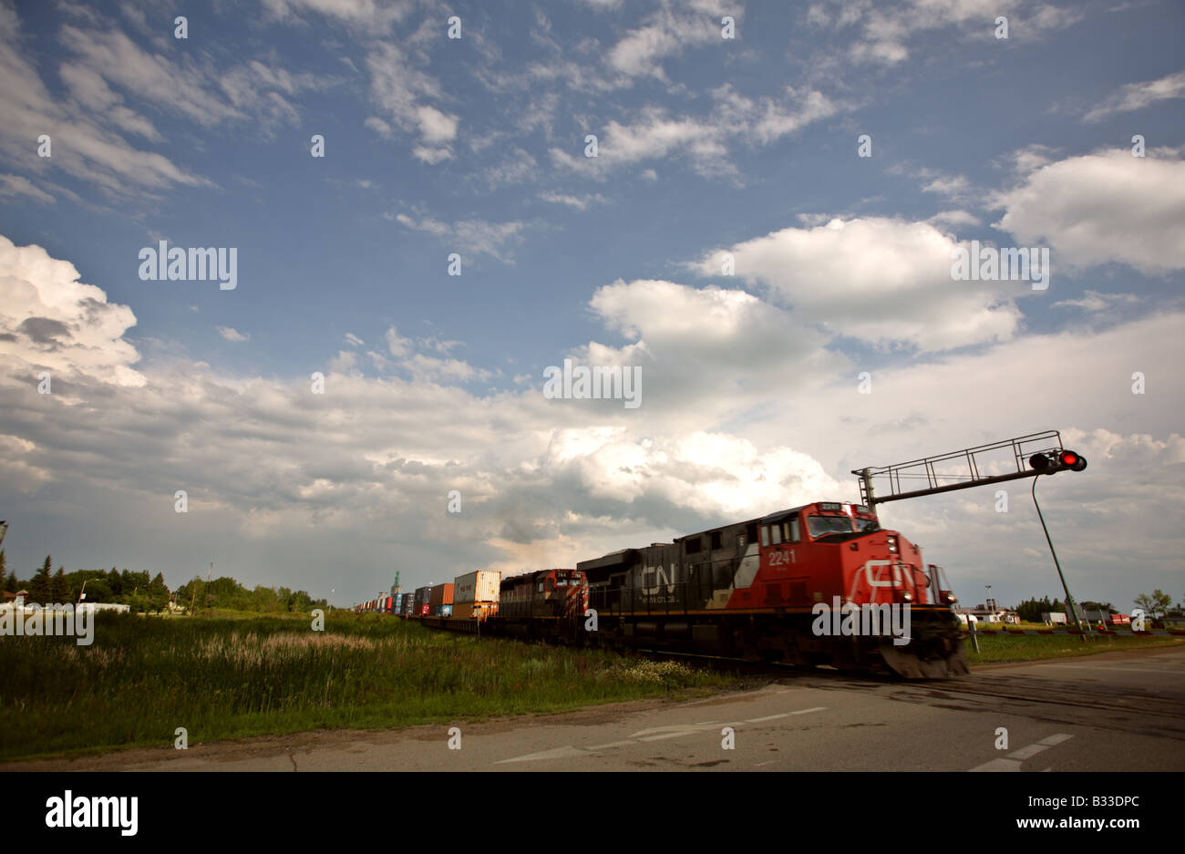 Train at road crossing Stock Photo - Alamy