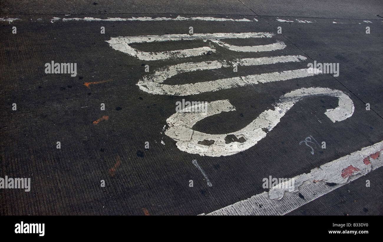 Bus lane text on road Stock Photo - Alamy