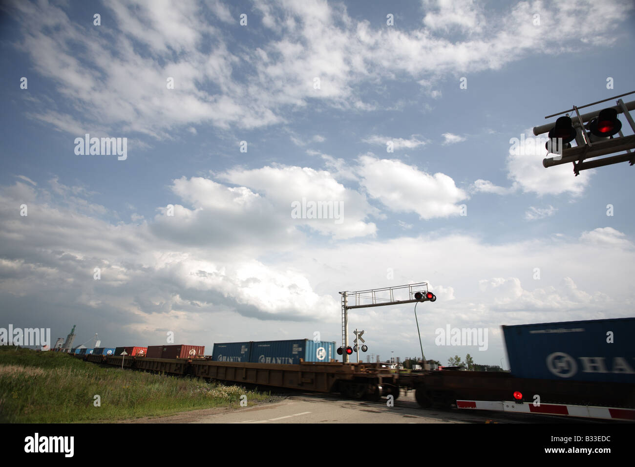 Container cars at road crossing Stock Photo - Alamy