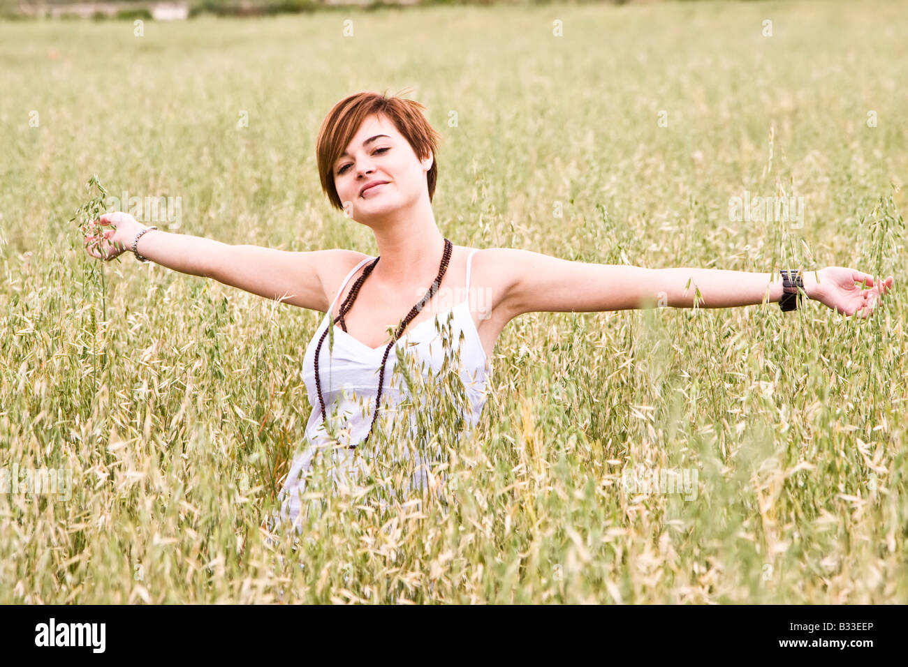 Woman feeling freedom in a field Stock Photo - Alamy