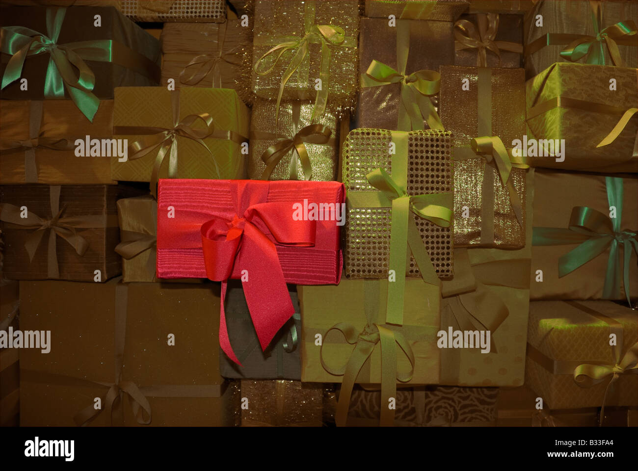 Unique composition of single red wrapped box among an extravagant array ...