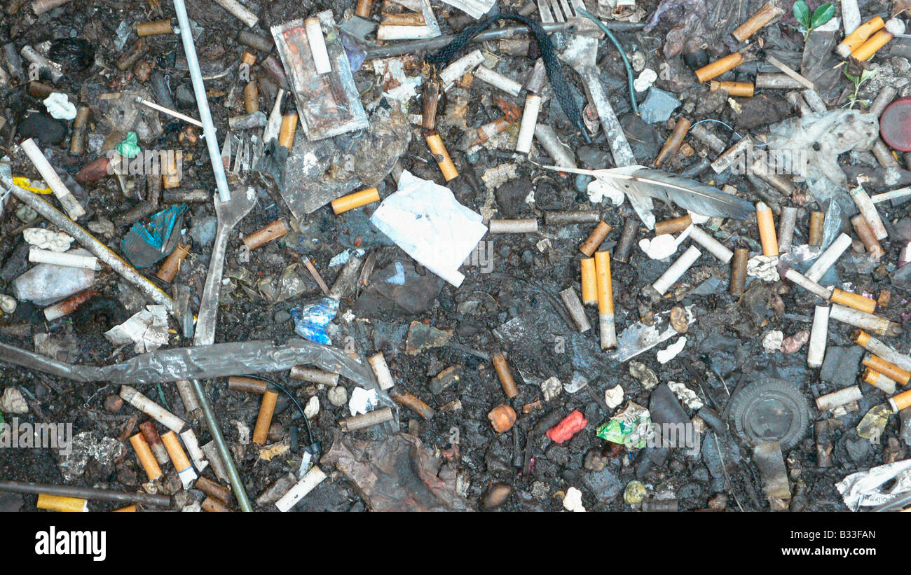 trash dropped through grate under sidewalk Stock Photo - Alamy