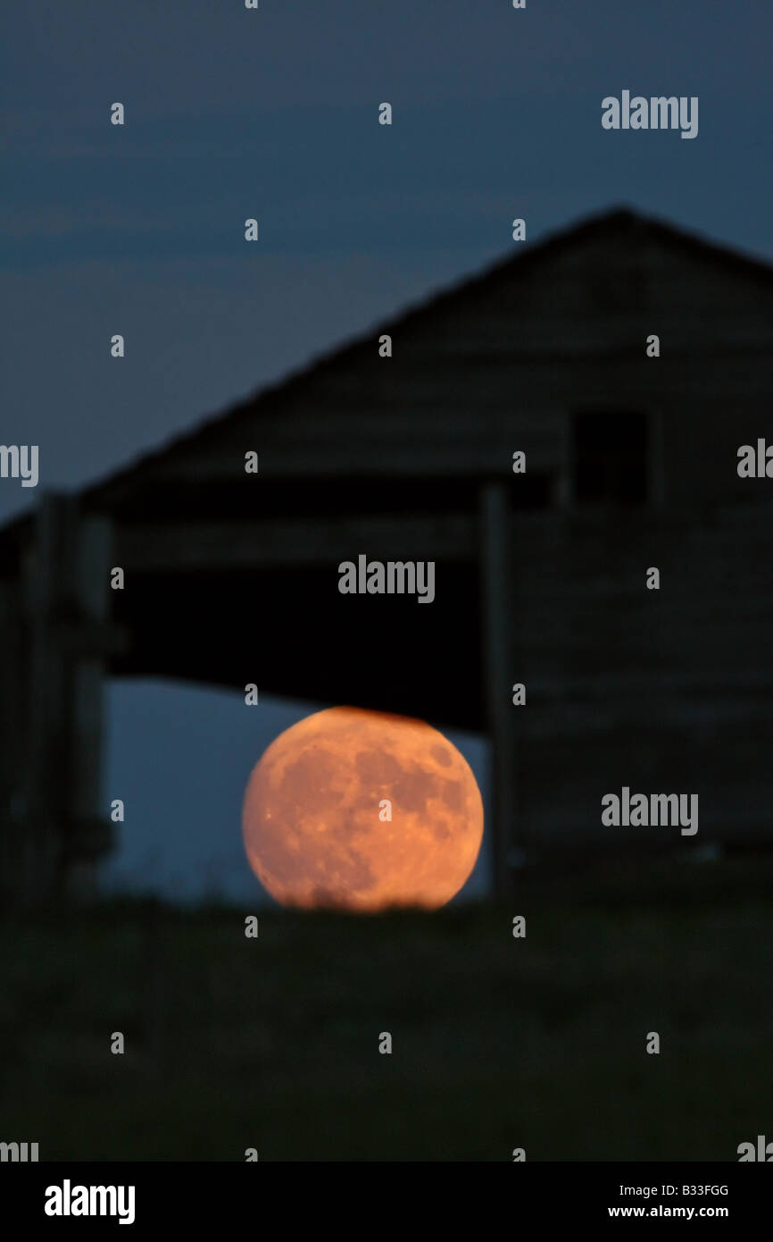 Full moon seen through old building window Stock Photo - Alamy