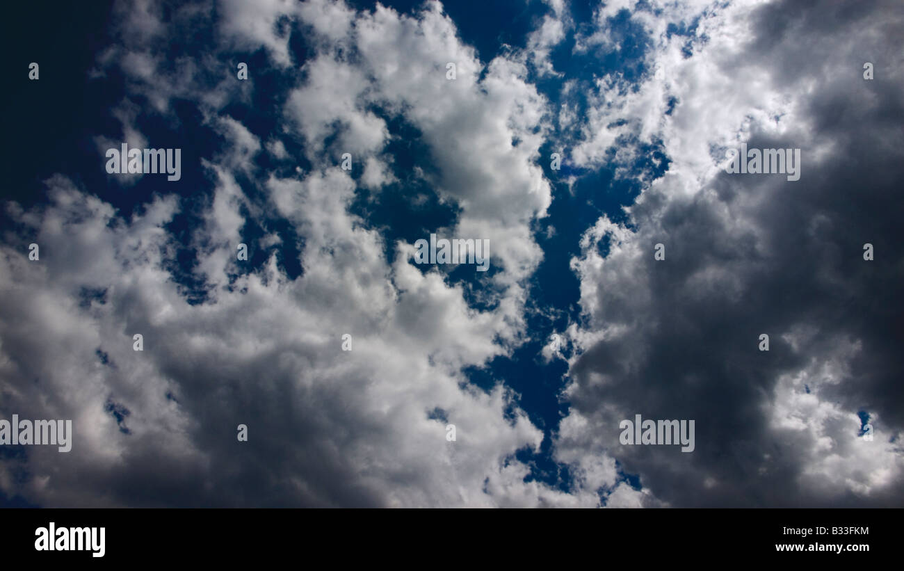 Dramatic dark blue sky and backlighting of dark fluffy clouds Stock ...