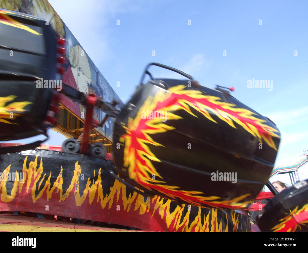 fair ground ride cars moving fast in sun Stock Photo - Alamy