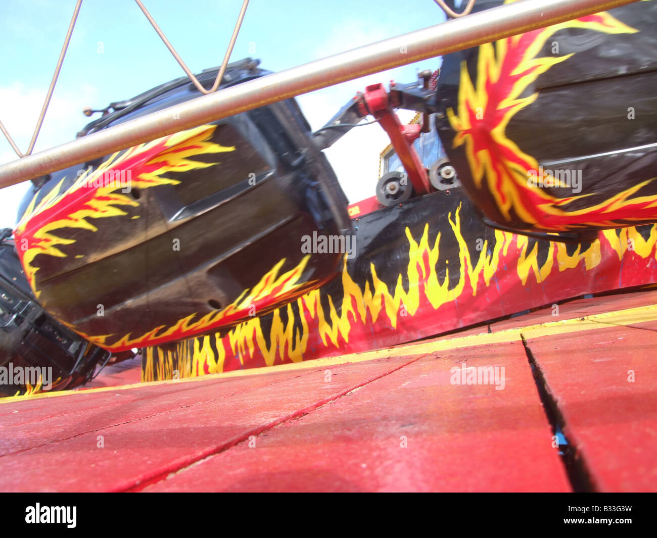 fair ground ride cars moving fast in sun Stock Photo - Alamy