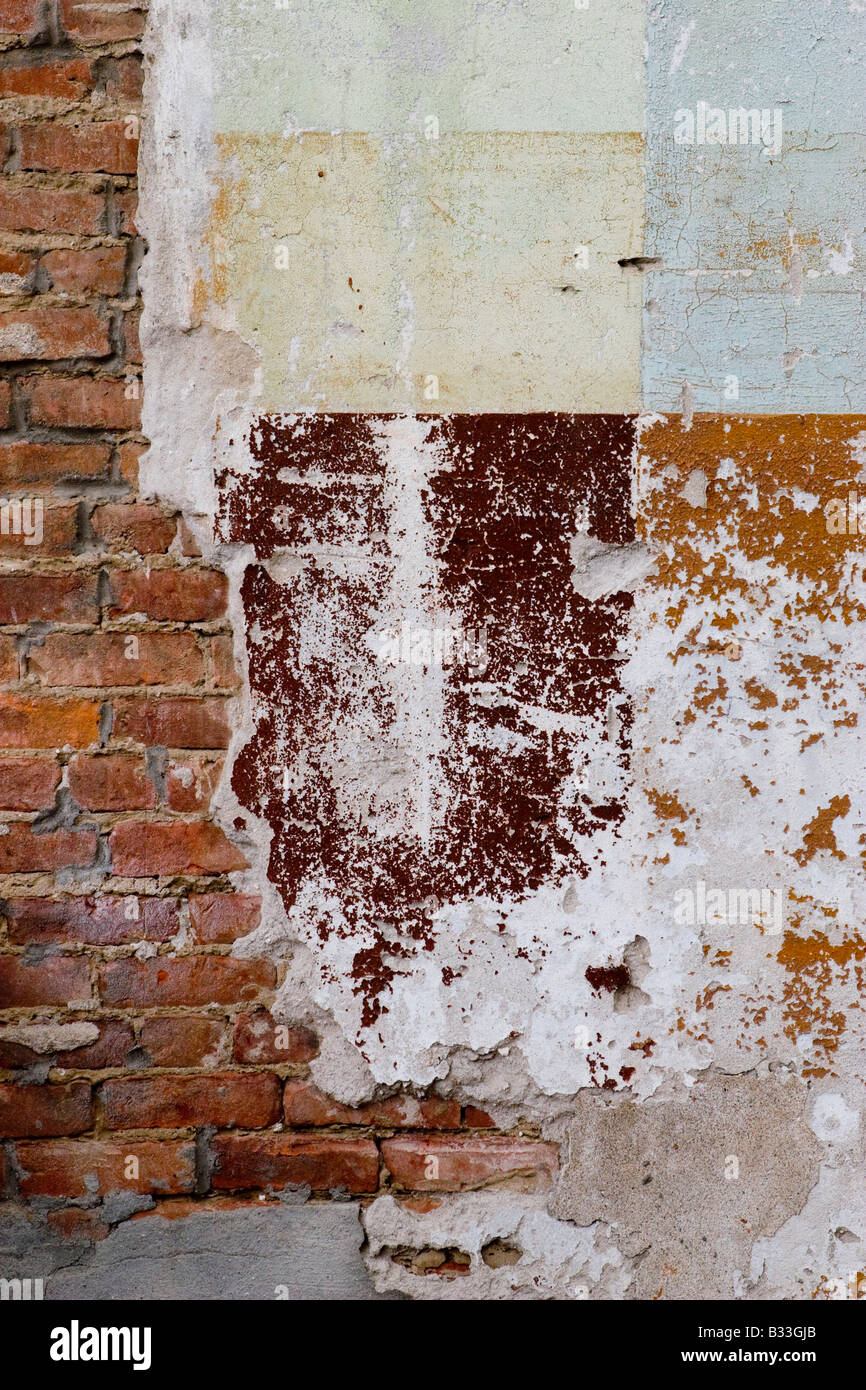 Flaking paint and cement on side of brick wall Stock Photo - Alamy