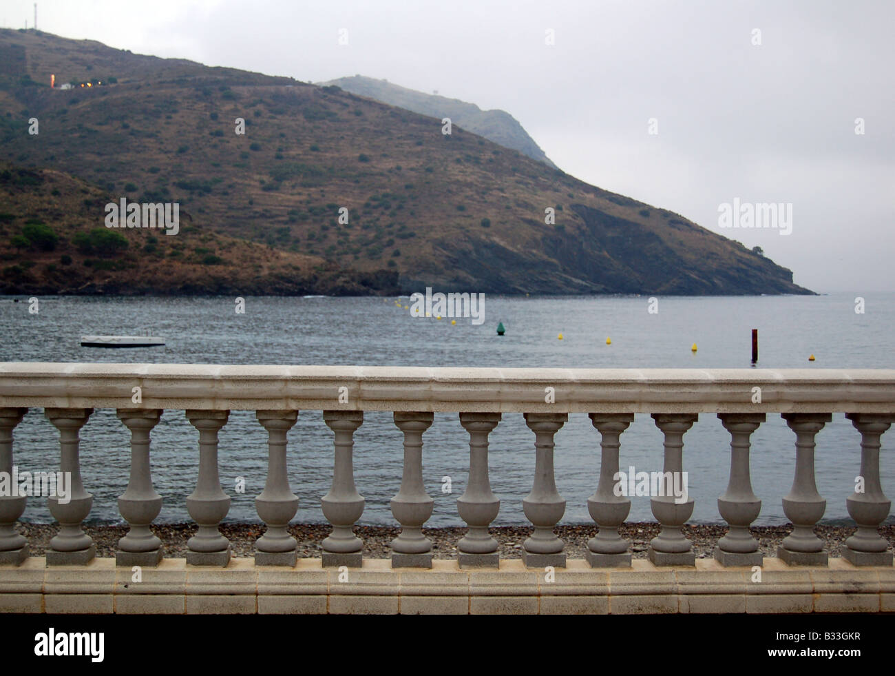 A balustrade frames the beautiful and serene view on a winding road ...