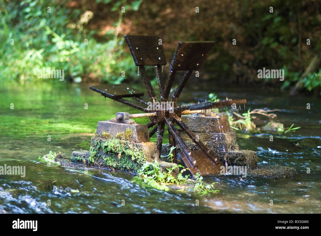 Small water wheel in an idyllic brook Stock Photo - Alamy