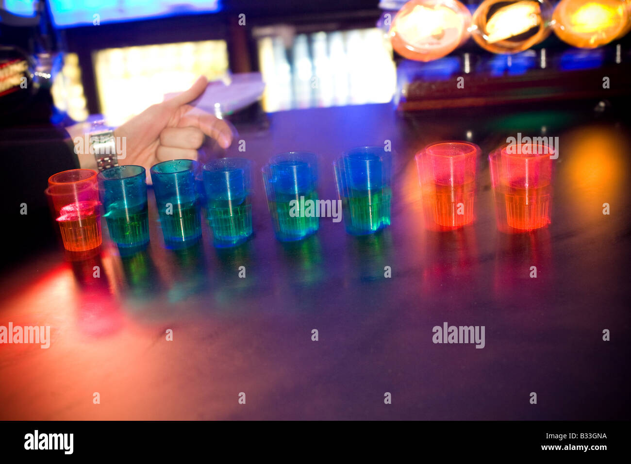 Alcoholic drinks lined up on a bar Stock Photo - Alamy
