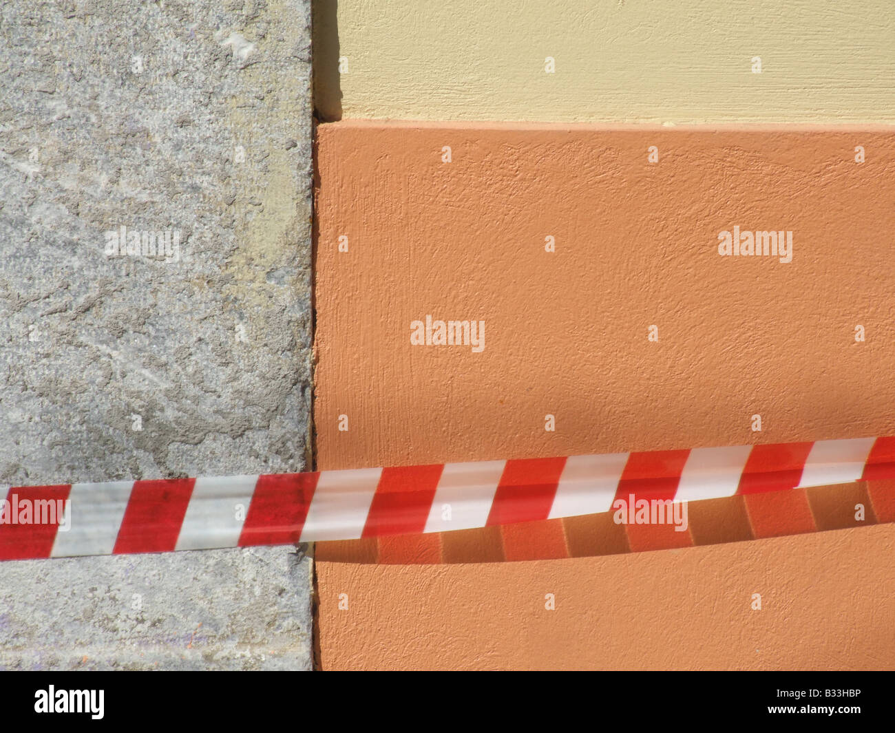 red white tape cordon reflection shadow on wall Stock Photo - Alamy