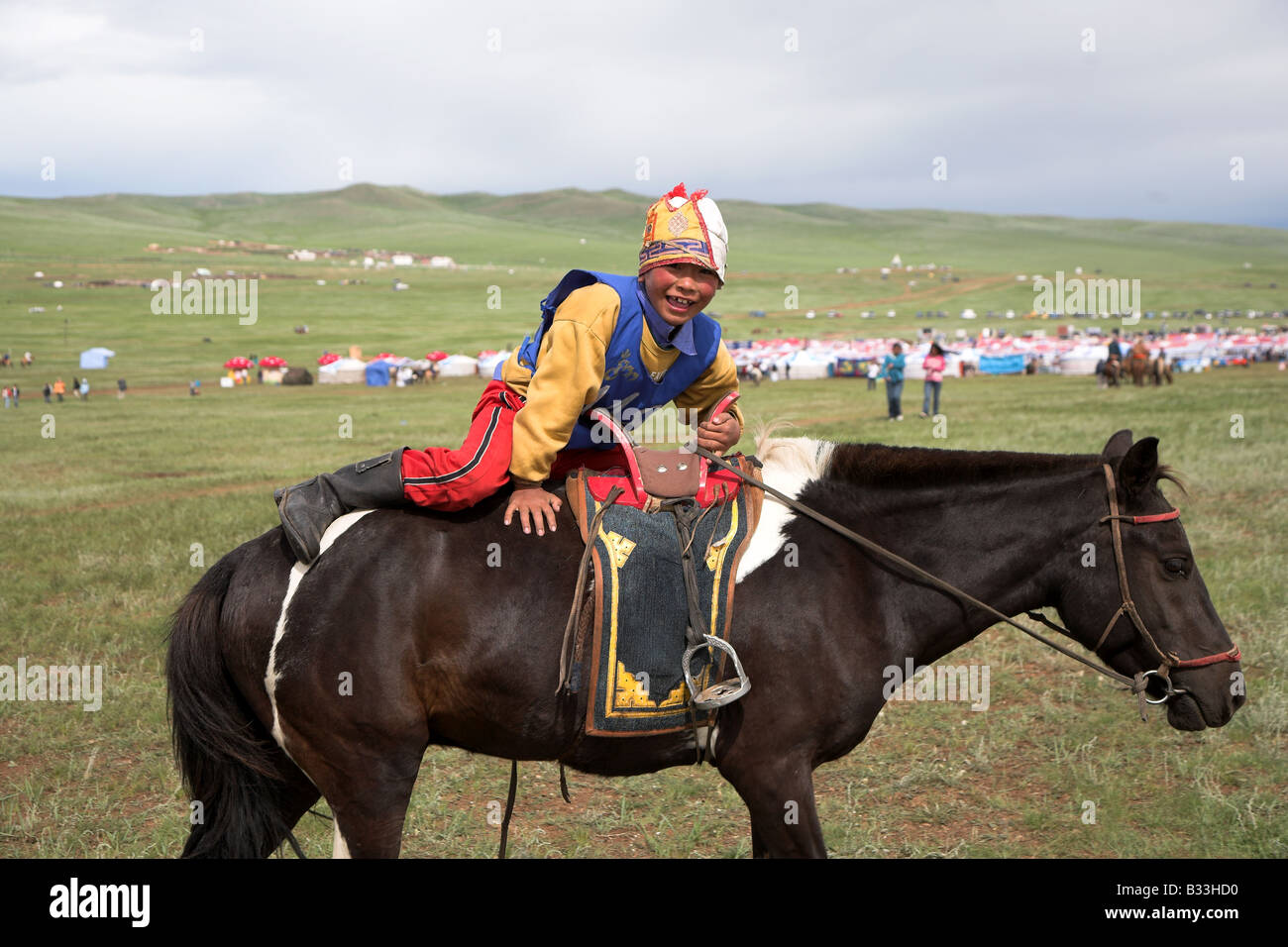 An mongolian child rider at the horse racing day as part of the Nadaam ...